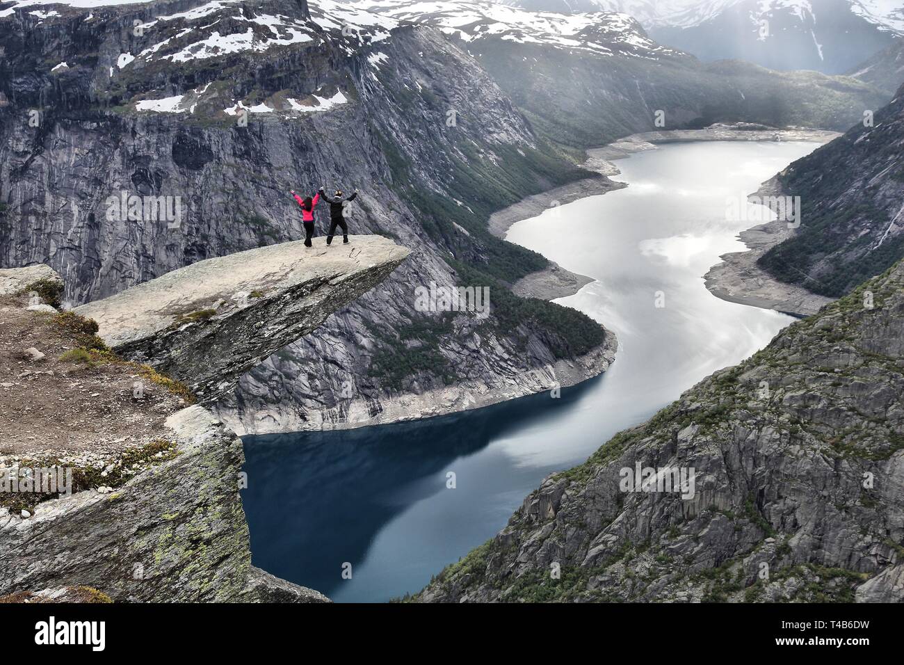 Tourists visit Troll's Tongue in Norway. Tourist attraction known as ...
