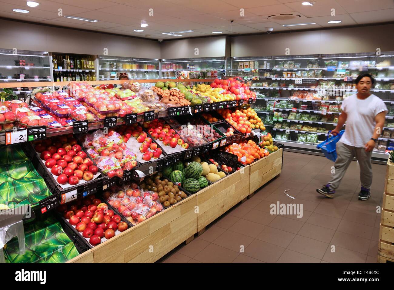 AMSTERDAM, NETHERLANDS - JULY 7, 2017: Customer visits a grocery store ...