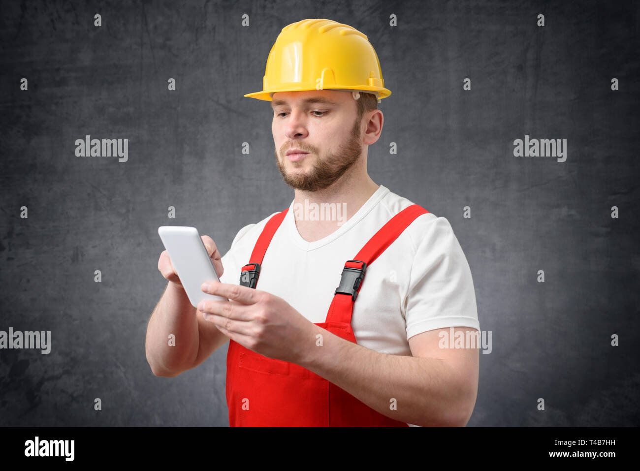 Construction worker using smartphone Stock Photo - Alamy