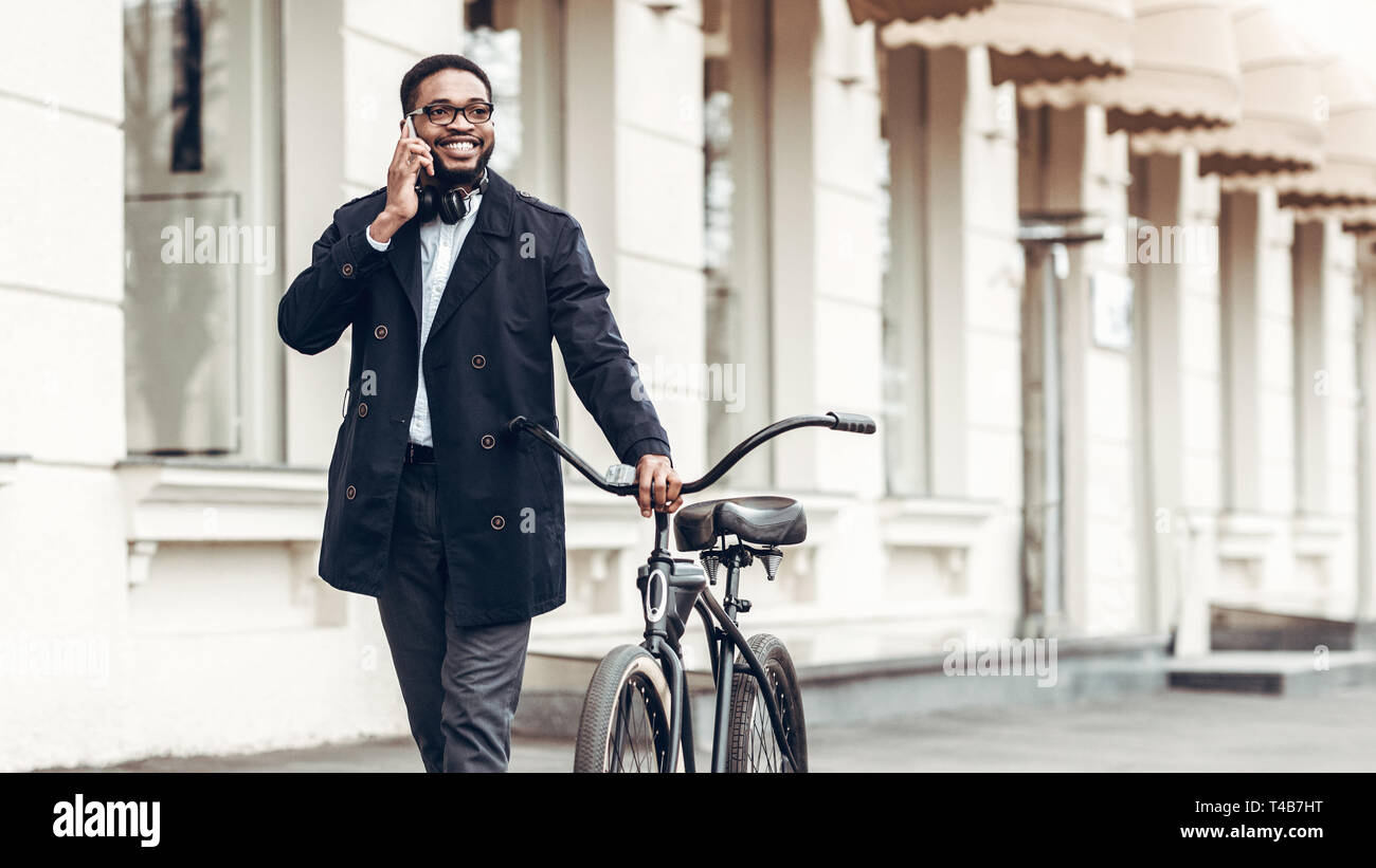 African-american businessman talking on phone, riding bicycle Stock ...