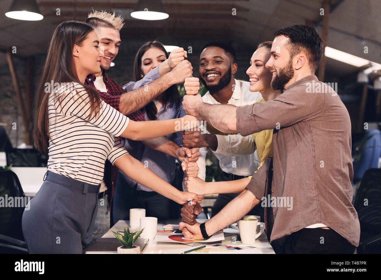 Cooperation and teambuilding concept. Colleagues building tower from ...