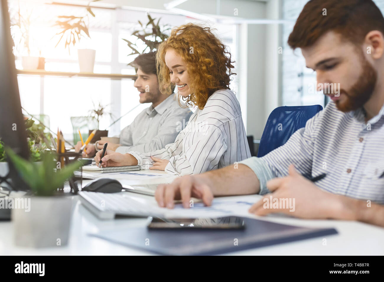 Young woman journalist working in public coworking space Stock Photo ...