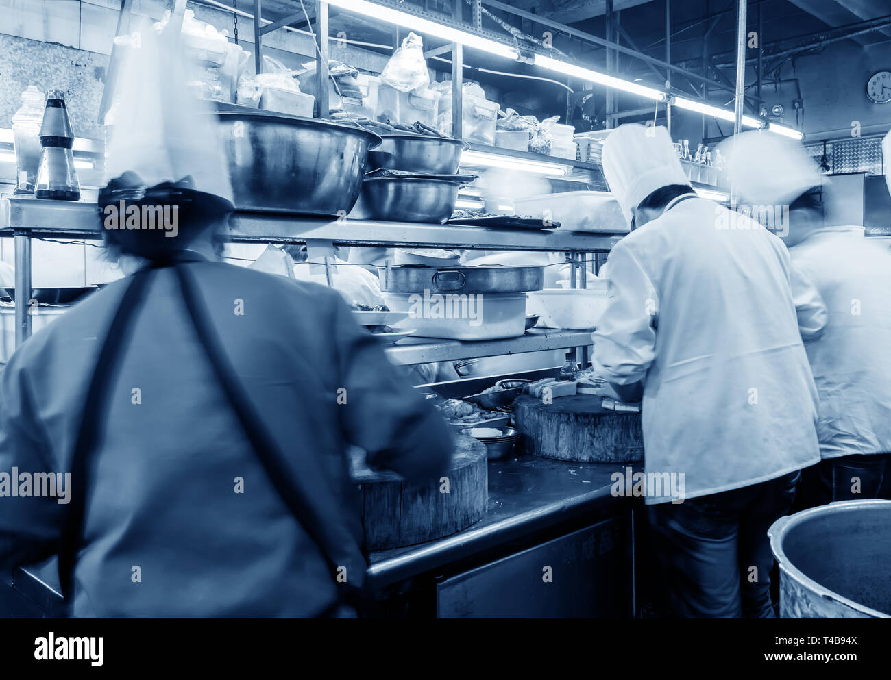 Crowded kitchen, a narrow aisle, working chef Stock Photo - Alamy