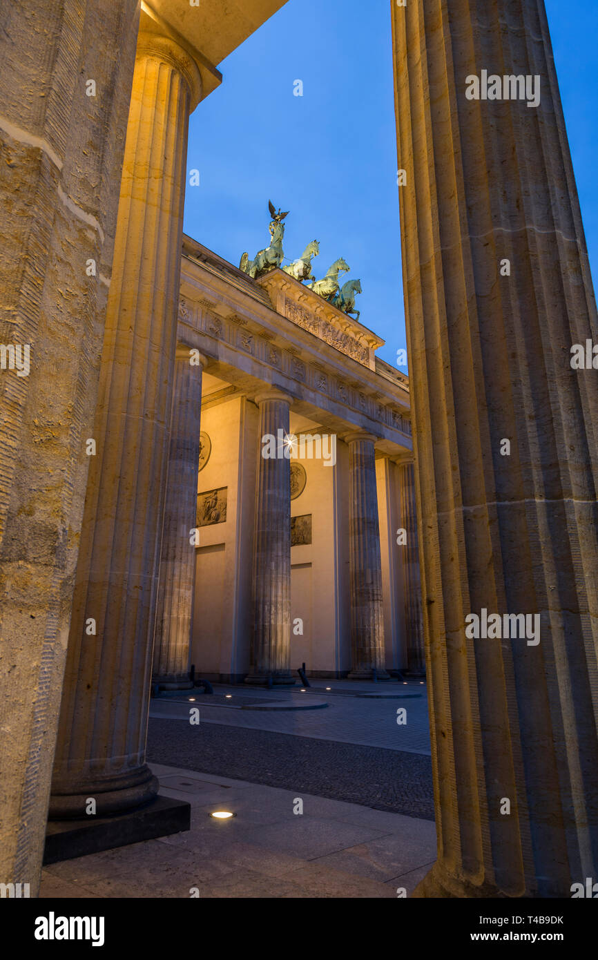 Famous illuminated neoclassical Brandenburg Gate (Brandenburger Tor) in Berlin, Germany, at dusk ...