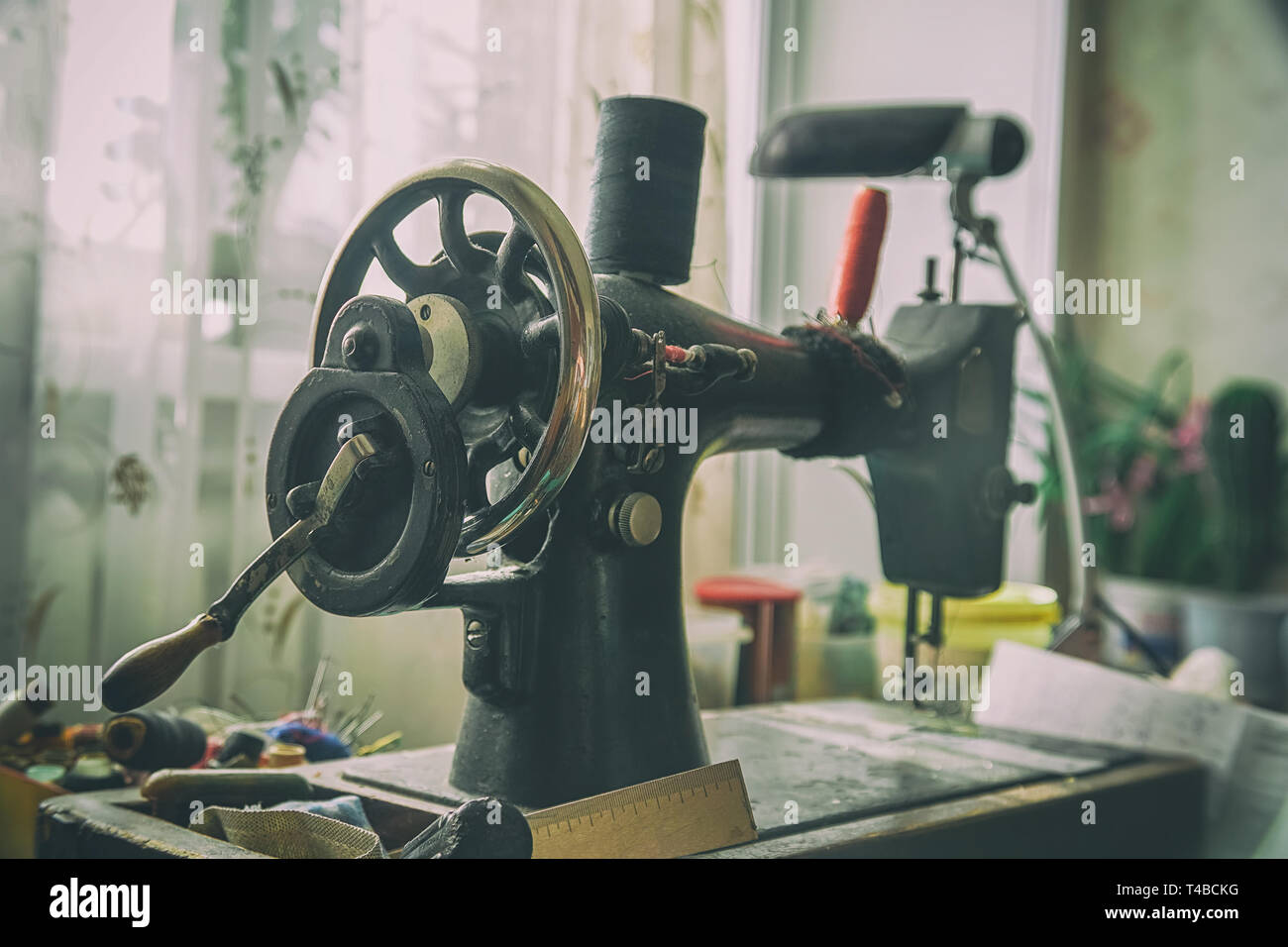 Old mechanical sewing machine on table Stock Photo - Alamy