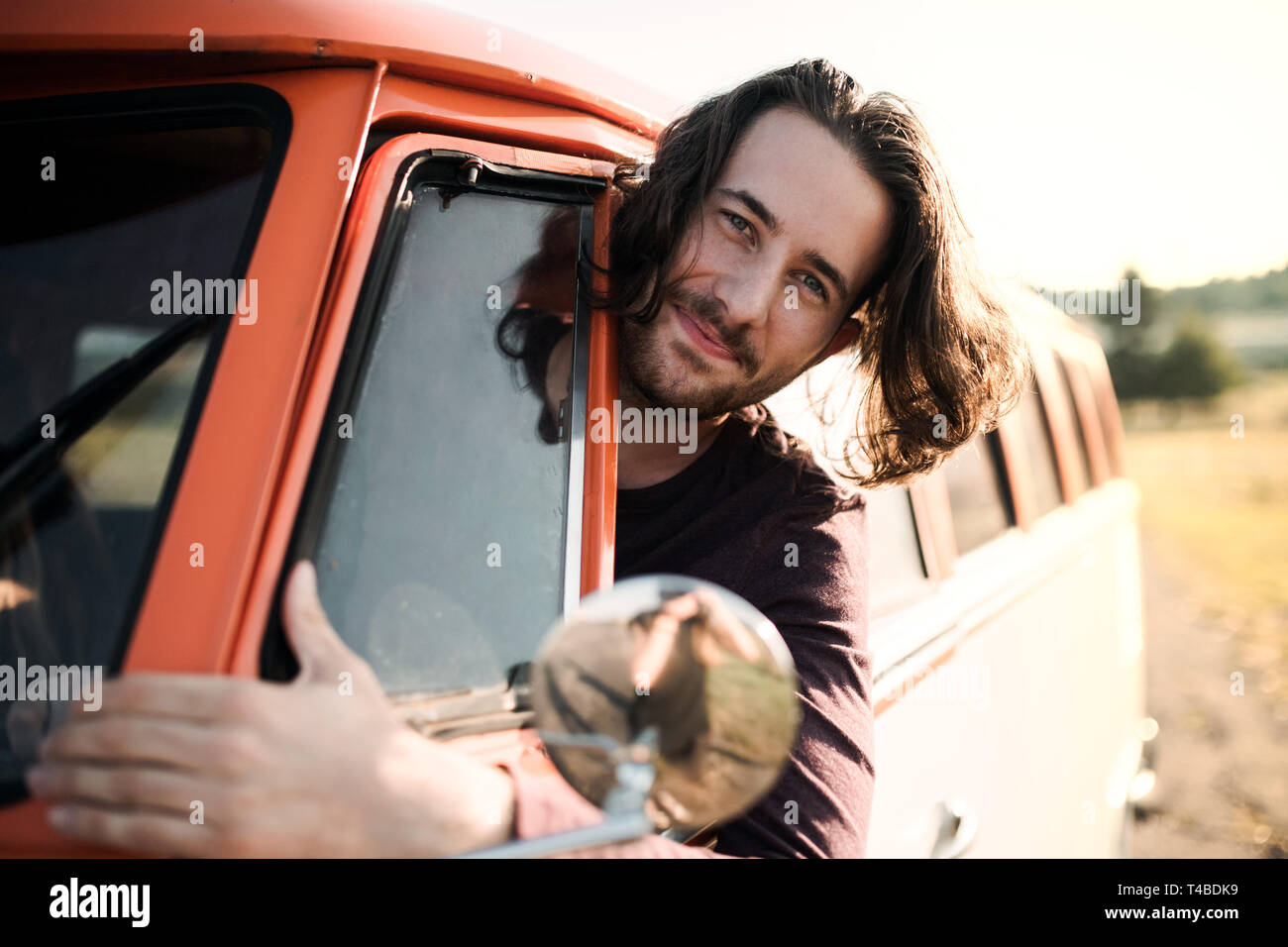 A young man driving a car on a roadtrip through countryside Stock Photo ...