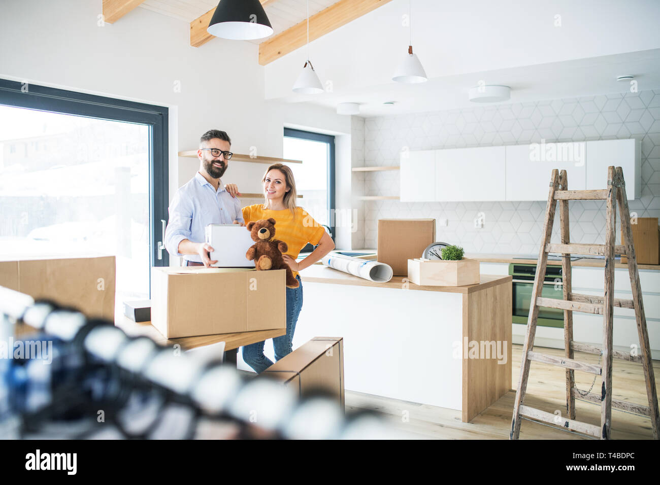 A young couple moving in new home Stock Photo - Alamy