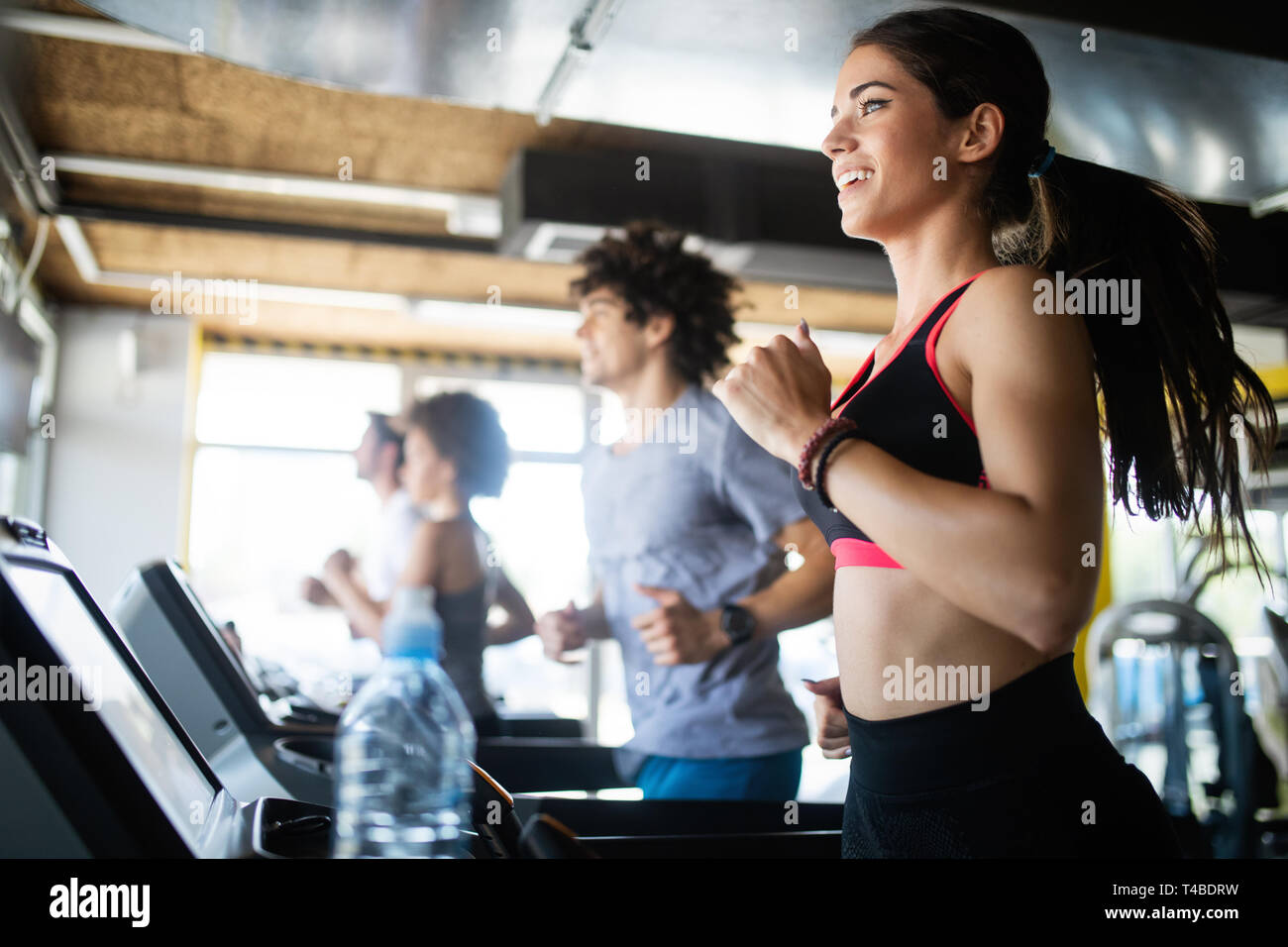 Beautiful fit people exercising together in gym Stock Photo - Alamy