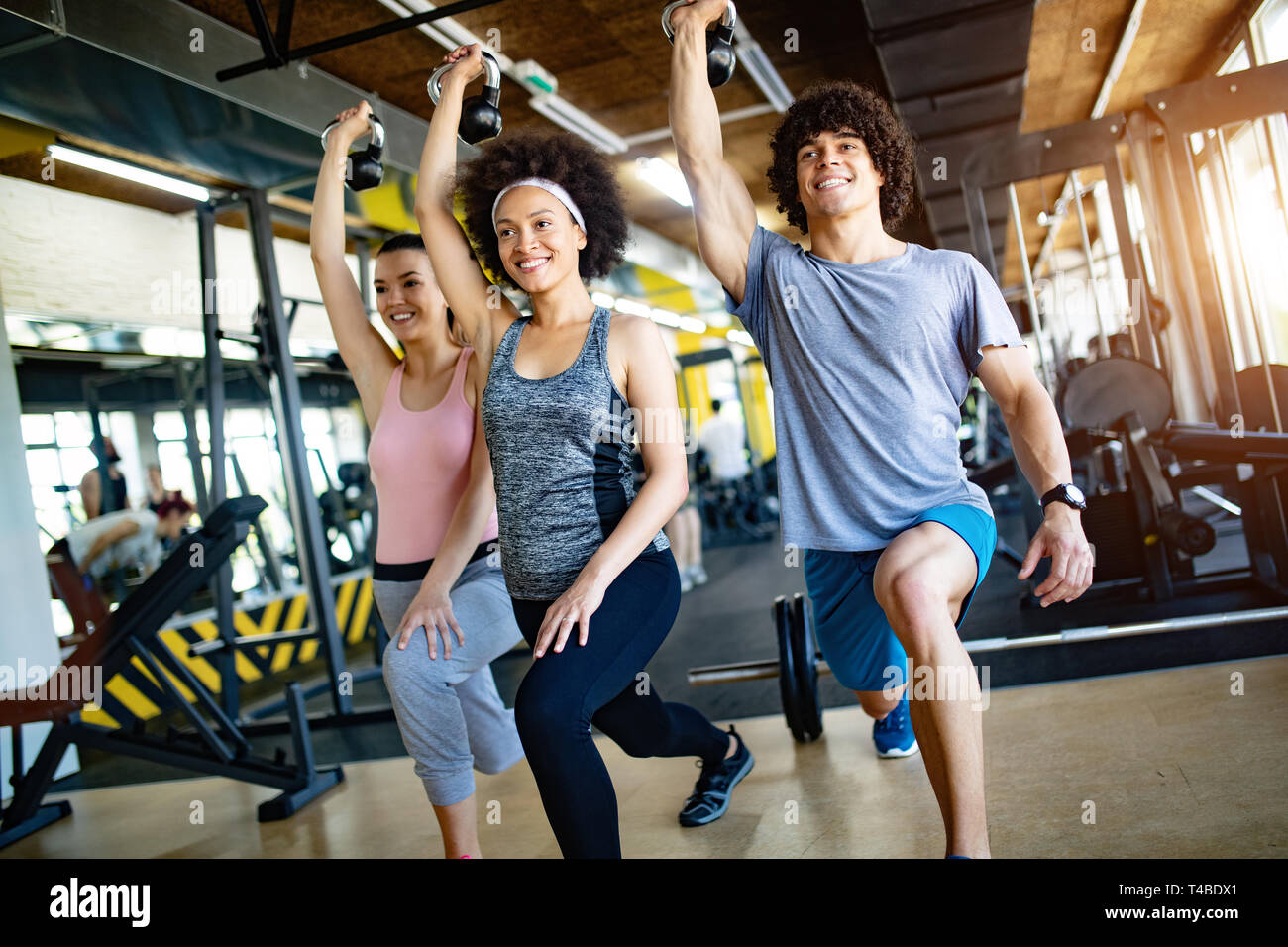 Picture of cheerful fitness team in gym Stock Photo - Alamy