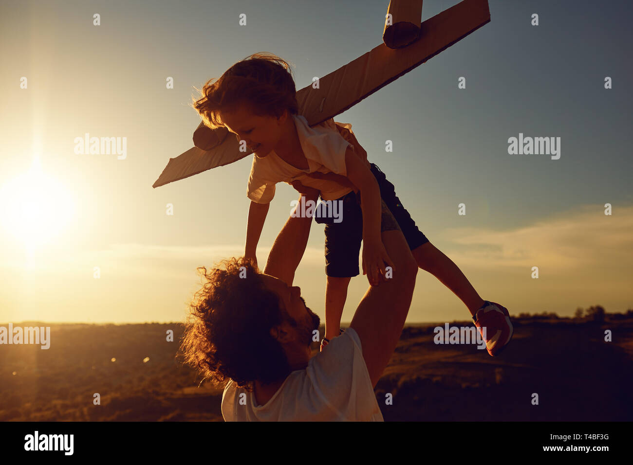 Father and child playing in nature at sunset Stock Photo - Alamy