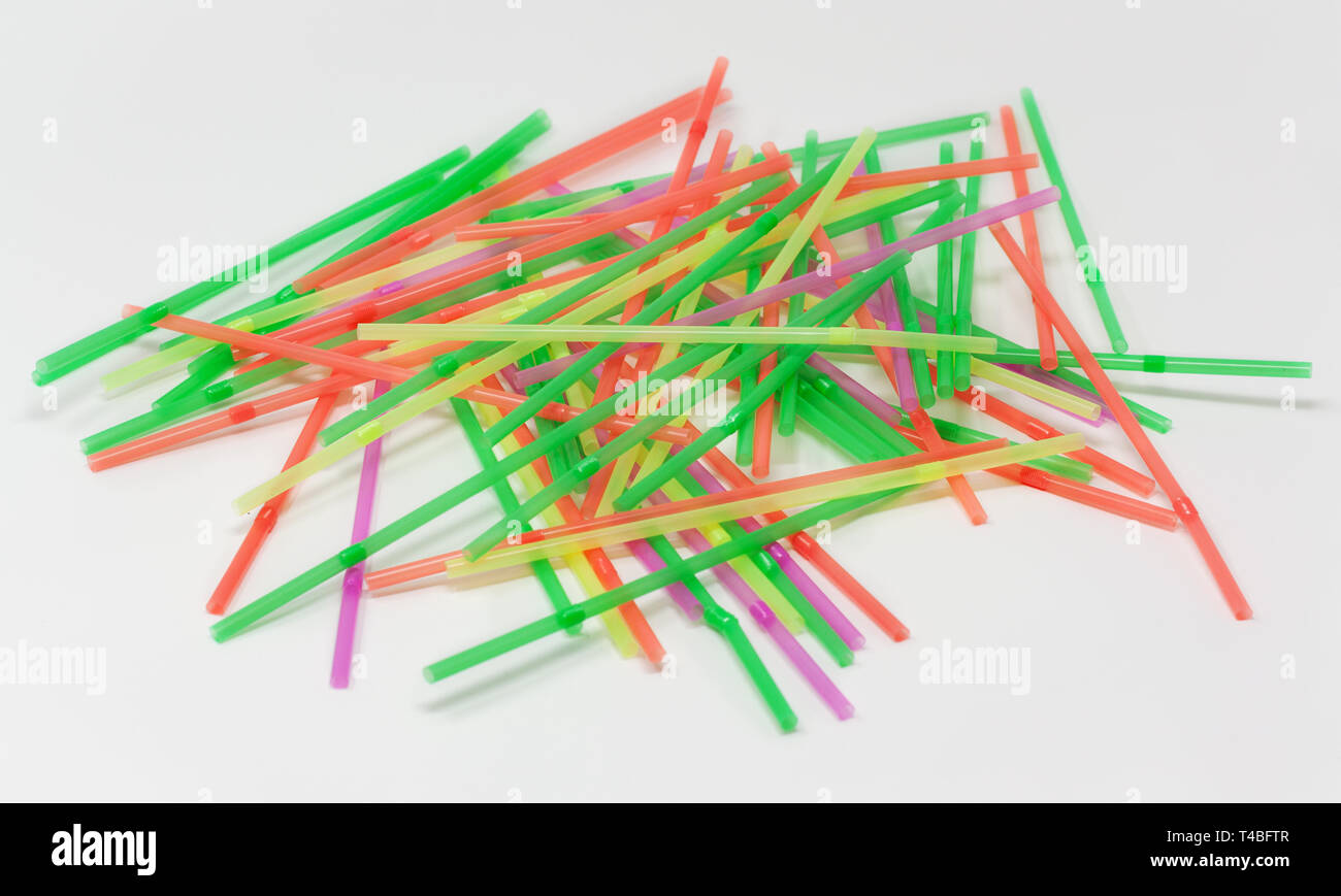 Pile of plastic straws scattered against a white background Stock Photo ...