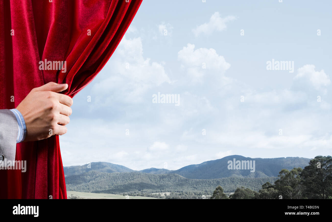 Human hand opens red curtain on natural landscape background Stock ...