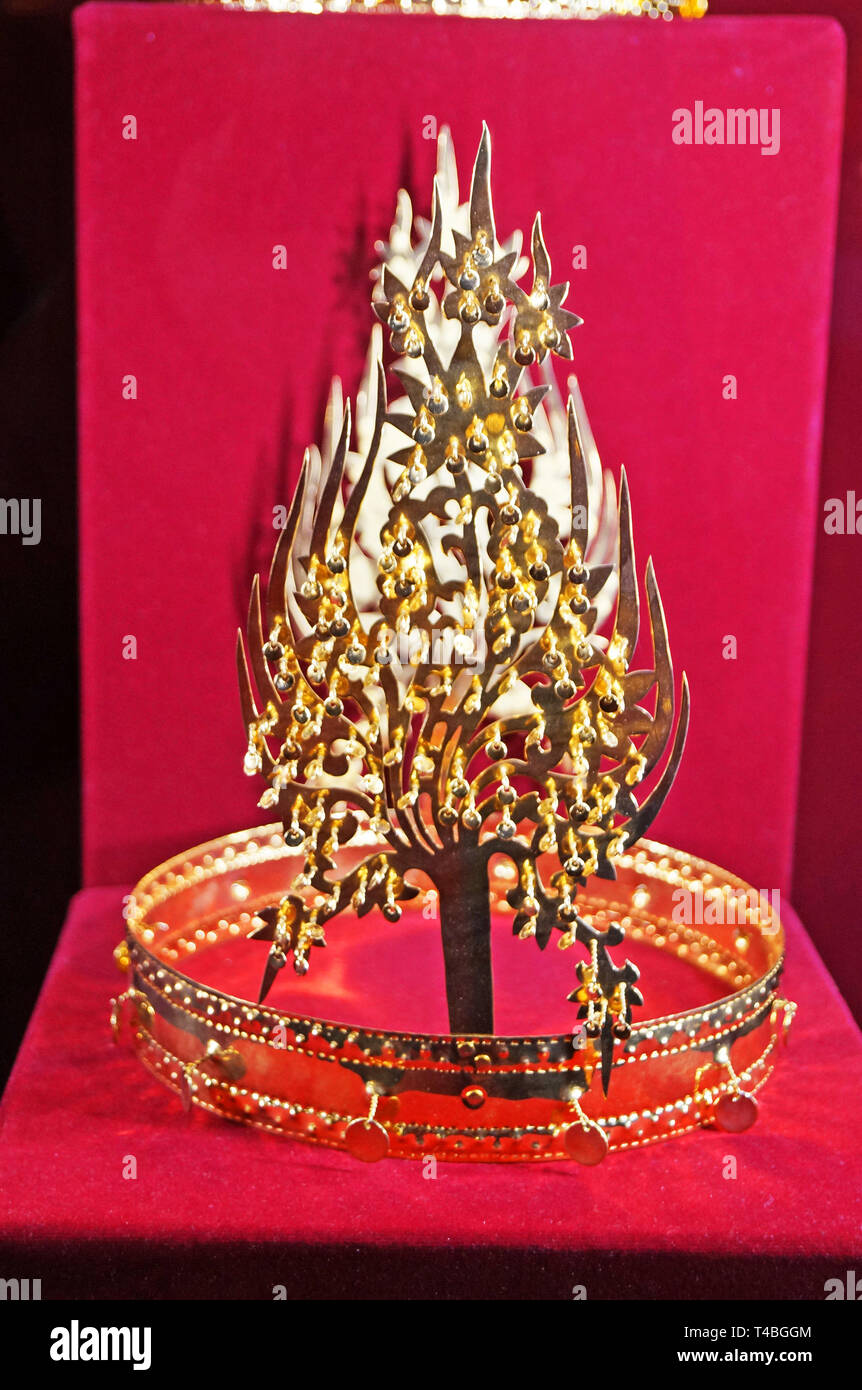 The royal crown made of gold and decorated with multi-colored precious ...
