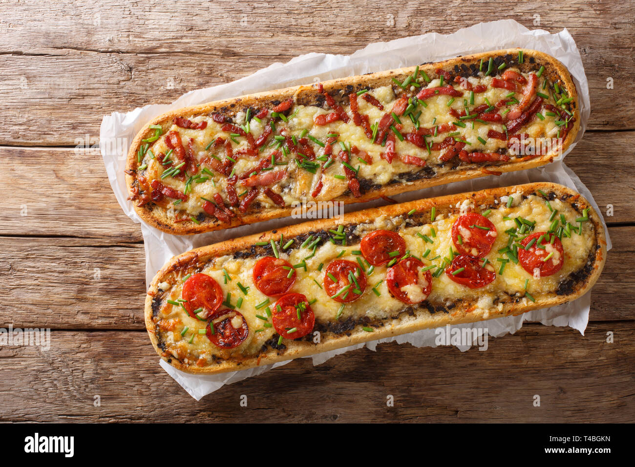Hot sandwiches with bacon, mushrooms, tomatoes and cheese close-up on ...
