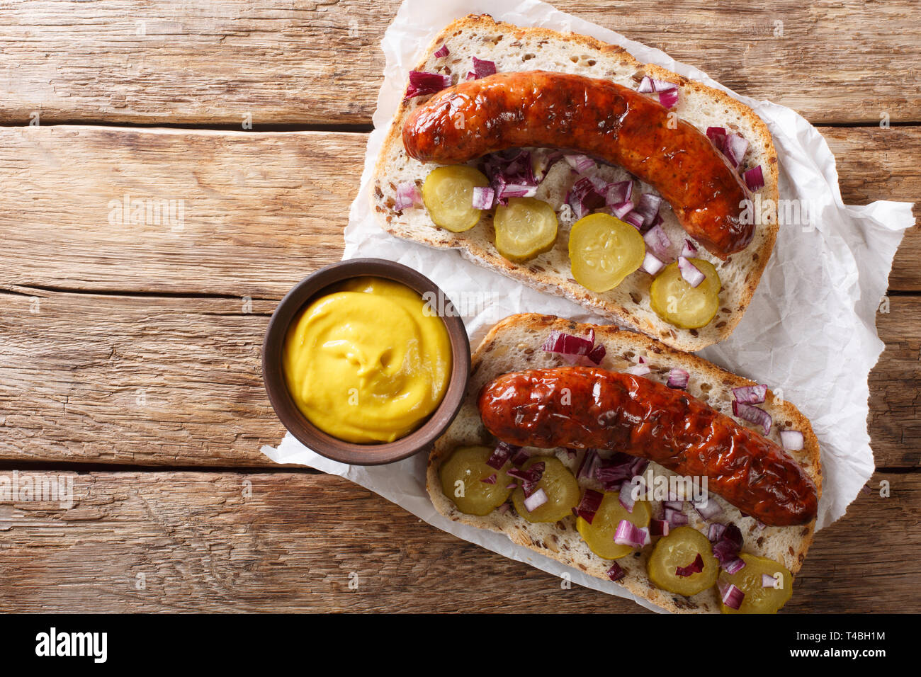 Austrian sandwiches with grilled sausages, pickled cucumbers, onions ...