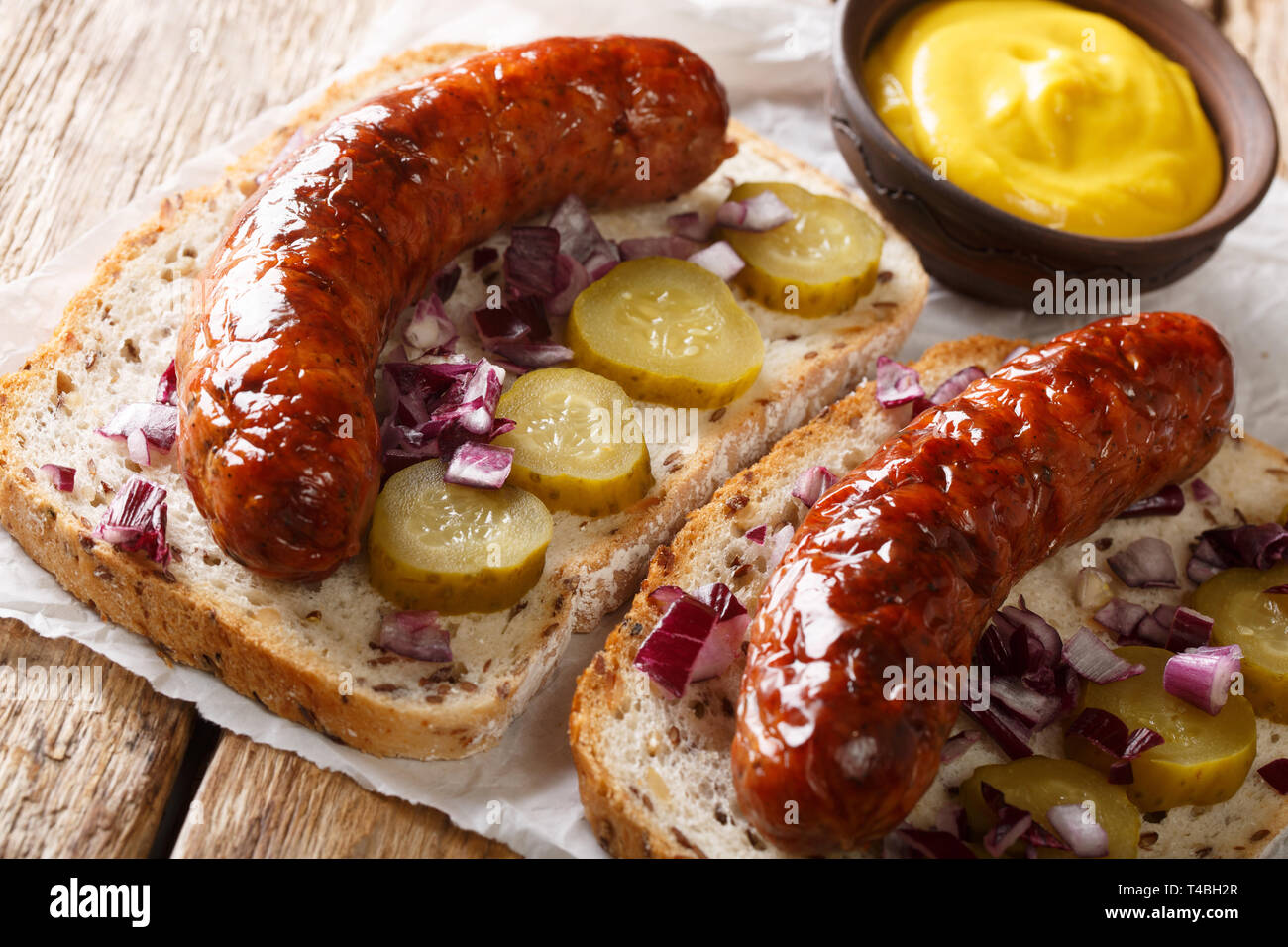 German street food sandwiches with grilled sausages, pickled cucumbers ...