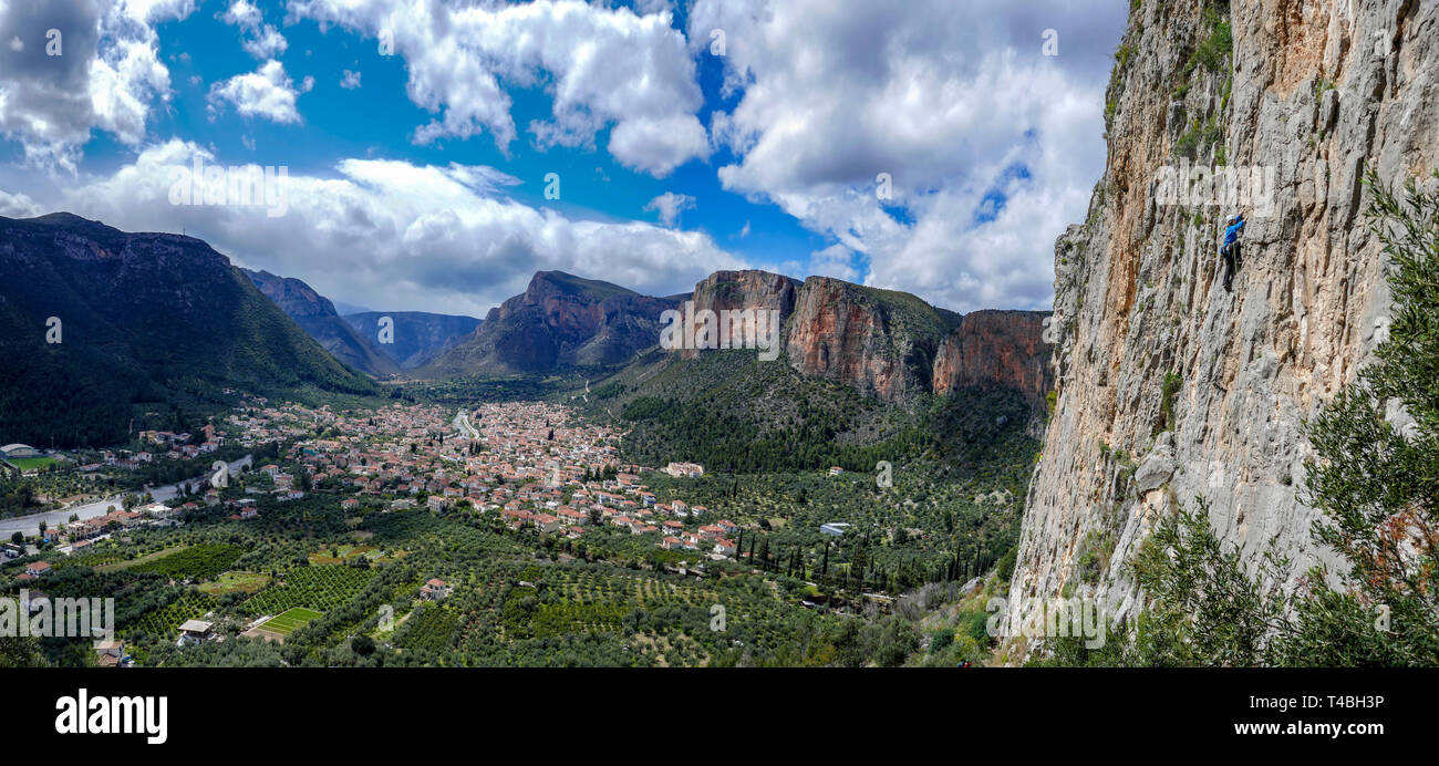 Lone female climber with panorama, above he small agricultural town of ...