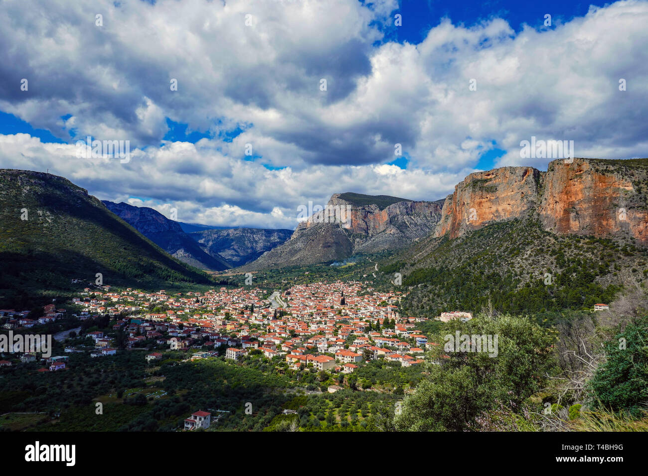 The small agricultural town of Leonidio surrounded by stark cliffs, the ...