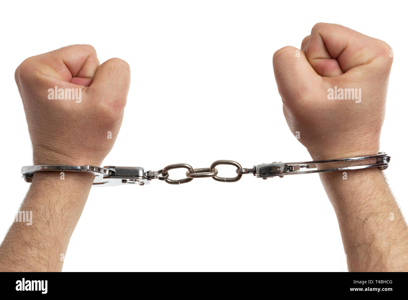 Closeup of man holding up handcuffed fists as arrest concept isolated ...