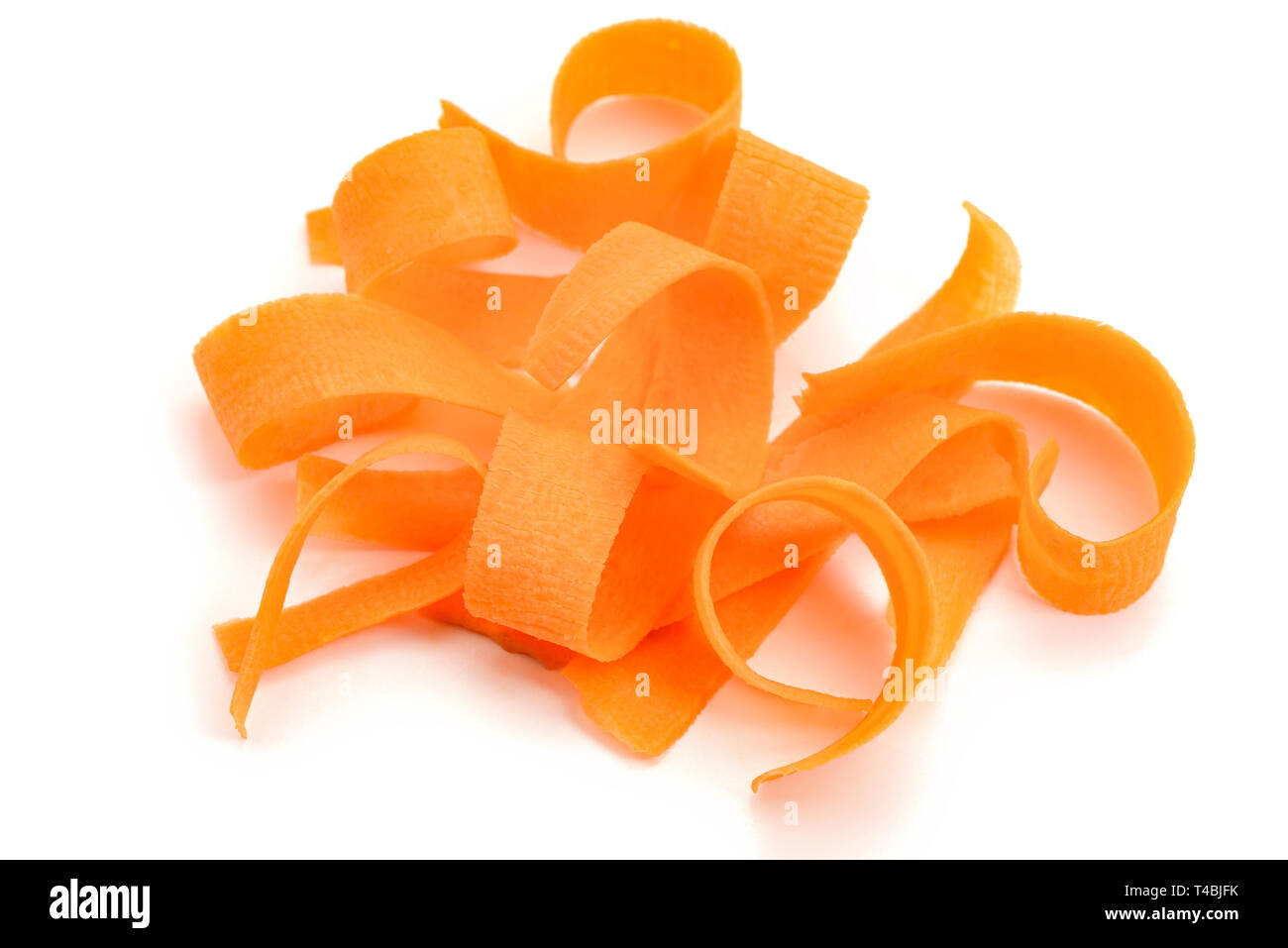Carrot shavings on white background Stock Photo - Alamy
