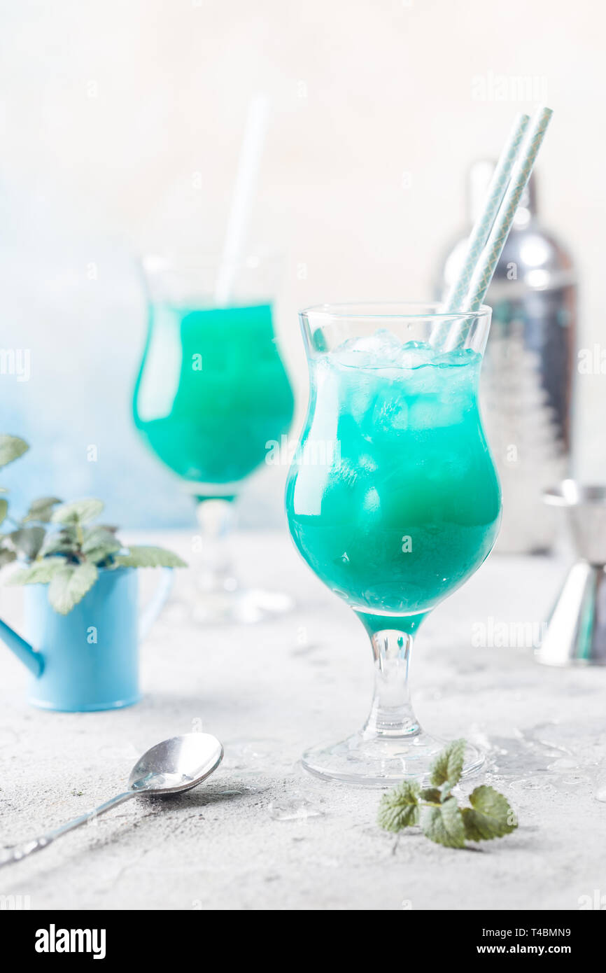 Colorful summer cocktail Blue Hawaii or iced blue lagoon alcohol drink ...