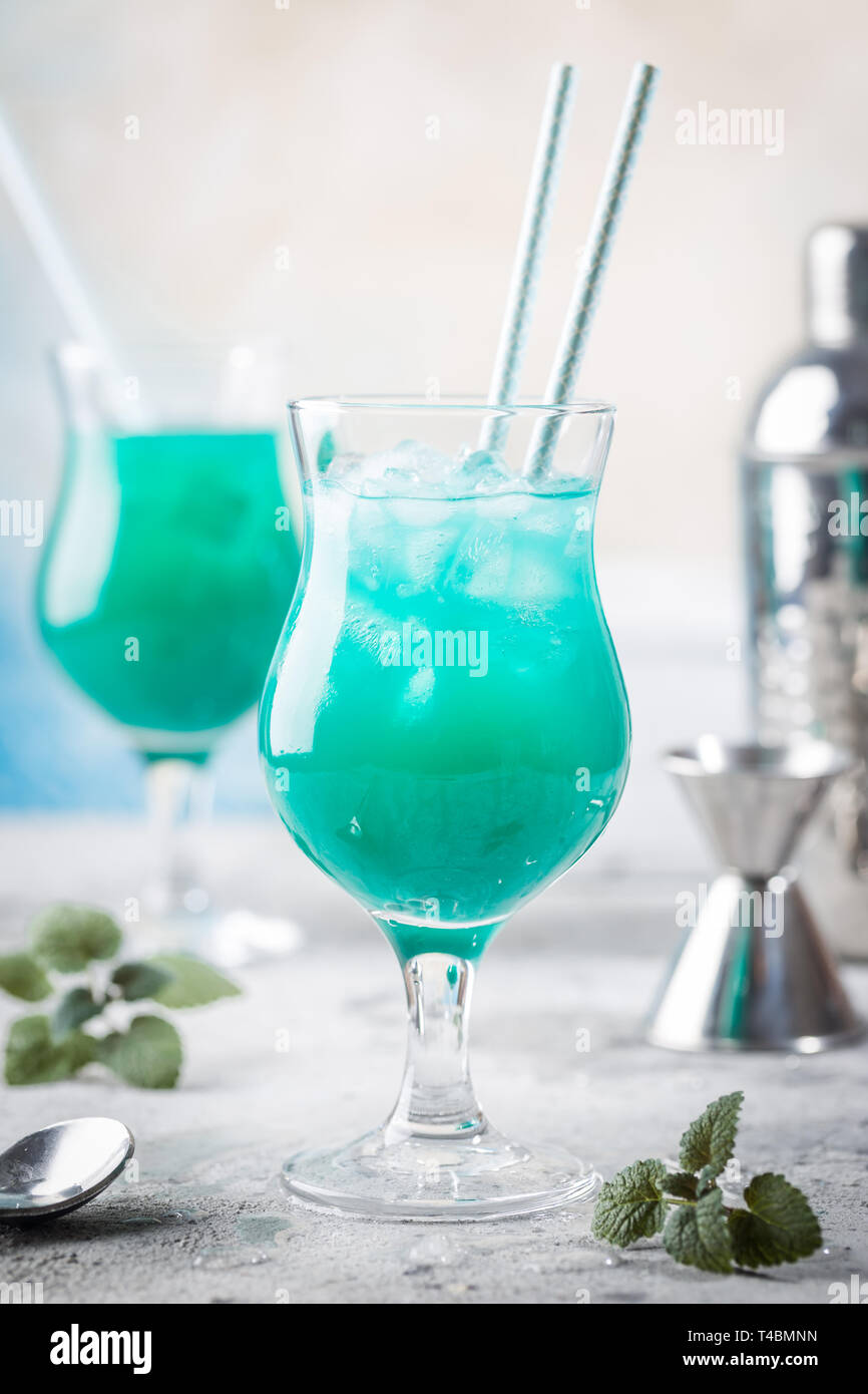 Colorful summer cocktail Blue Hawaii or iced blue lagoon alcohol drink ...