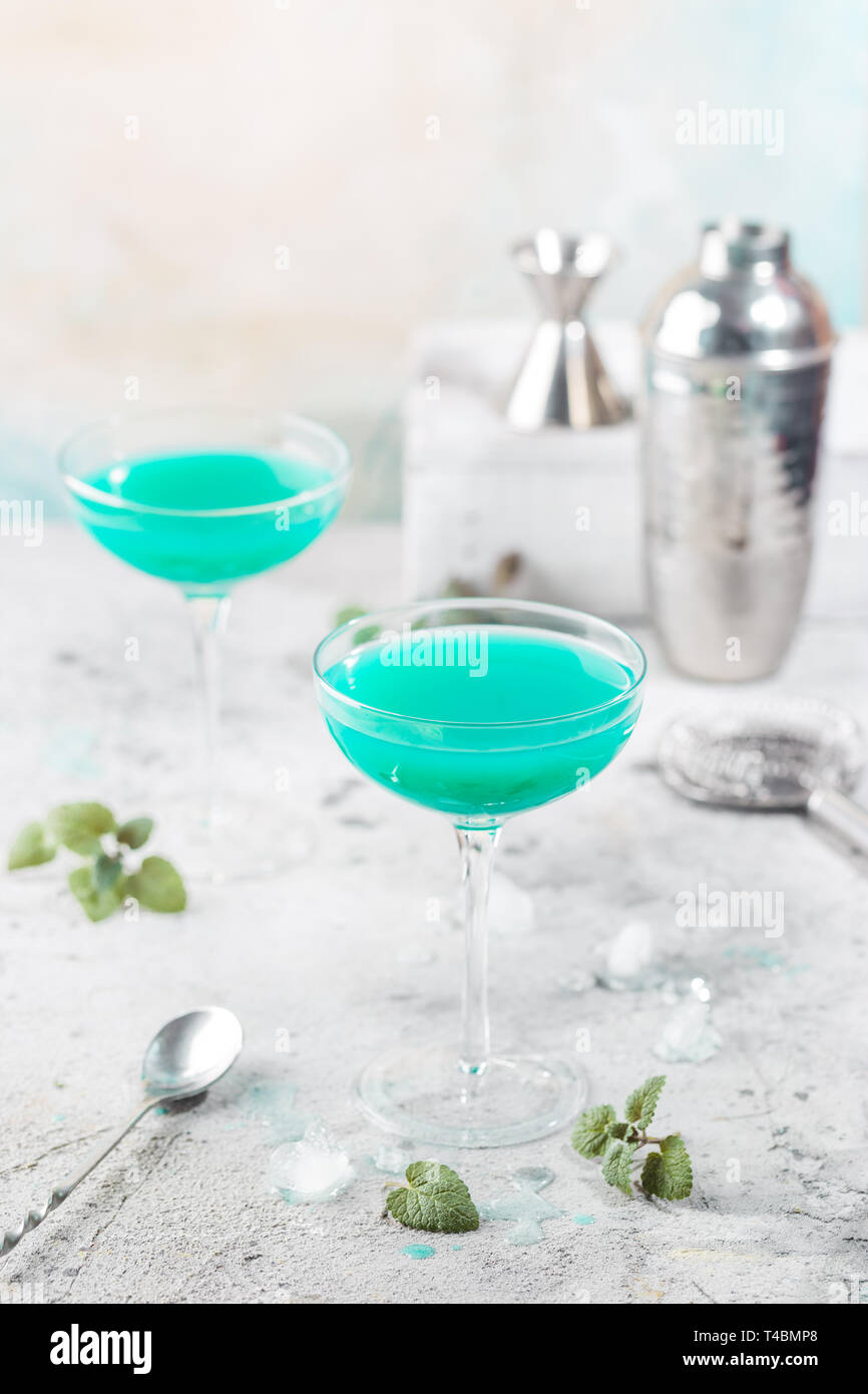 Colorful summer cocktail Blue Hawaii or iced blue lagoon alcohol drink ...