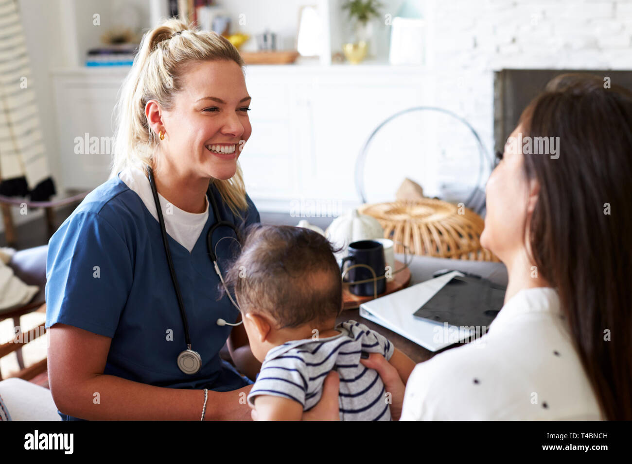 Female healthcare worker visiting a young mum and her infant son at ...