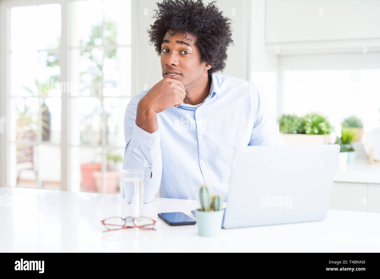 African American business man working using laptop serious face ...