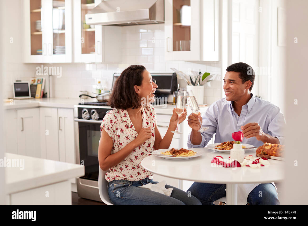 Young romantic couple raising toast hi-res stock photography and images ...