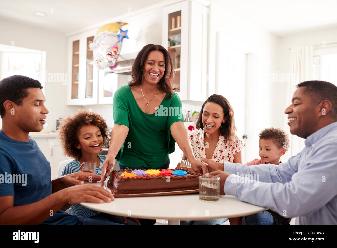 Three generation family family sitting together in the kitchen ...