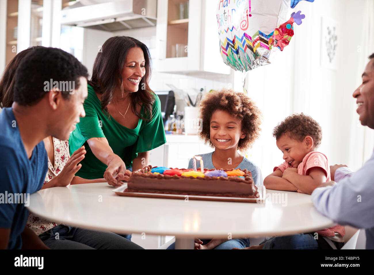 Close up of three generation family sitting together at the kitchen ...