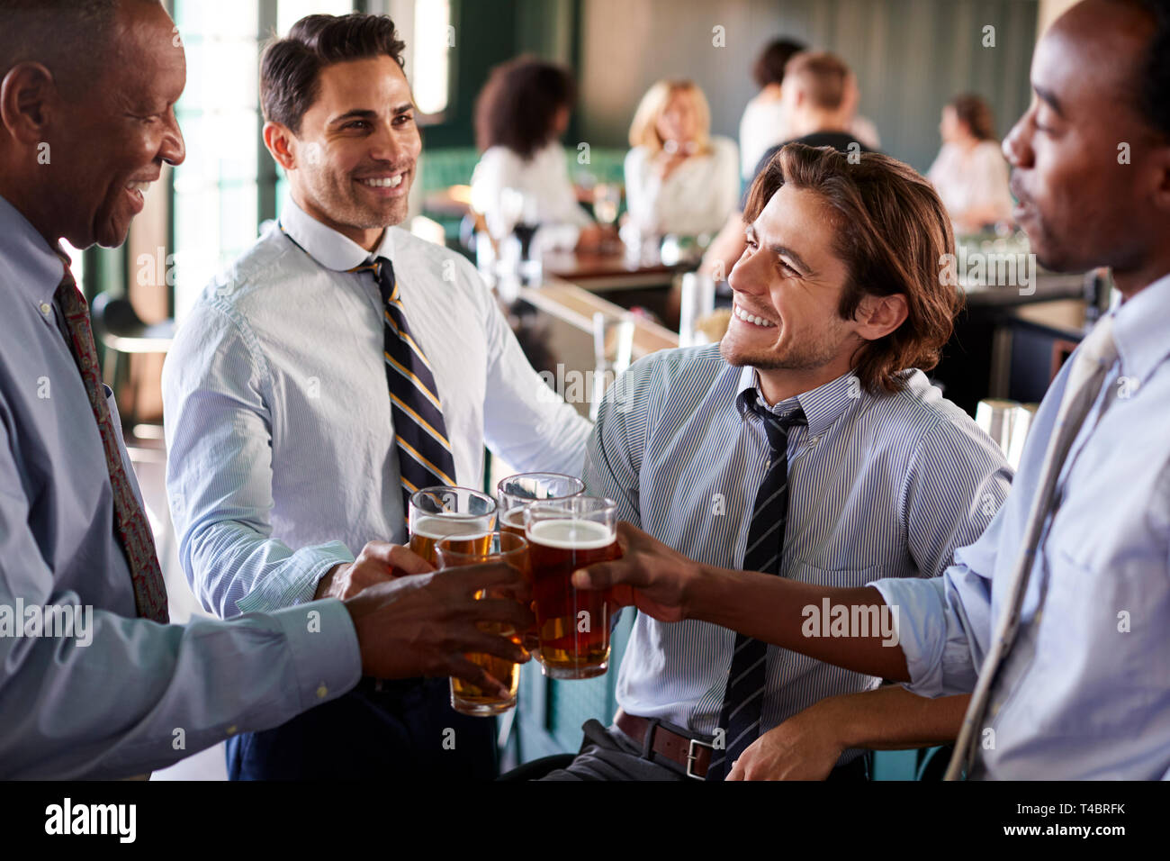 Group Of Businessmen Celebrating With Drinks After Work In Bar Stock ...