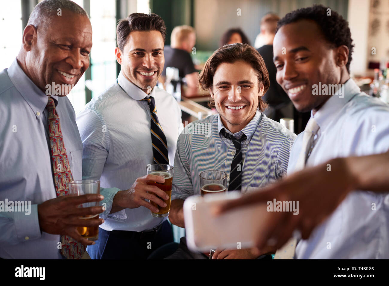 Group Of Businessmen Taking Selfie In Bar At After Work Drinks In Bar ...