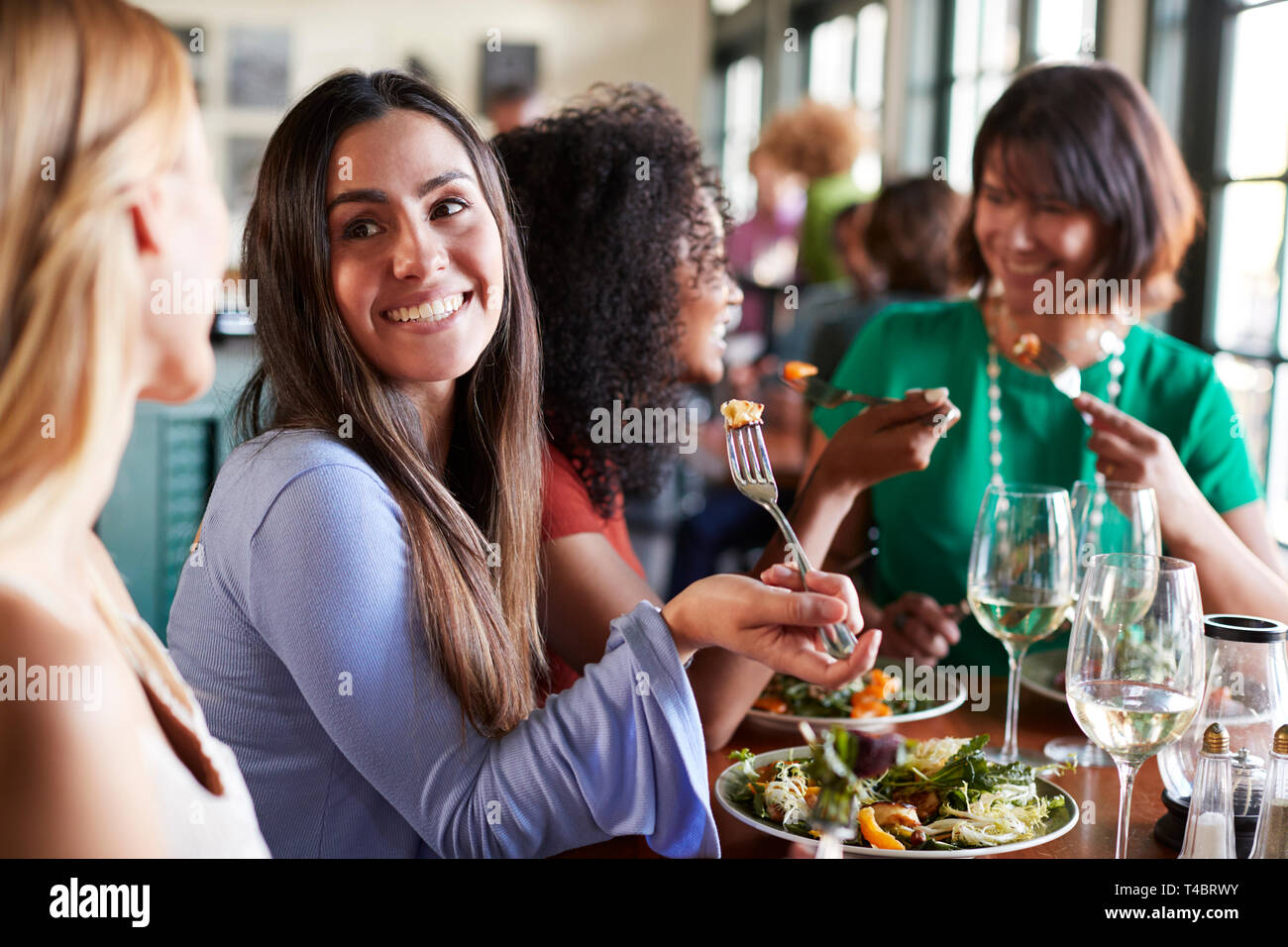 Group Of Female Friends Enjoying Meal In Restaurant Together Stock ...