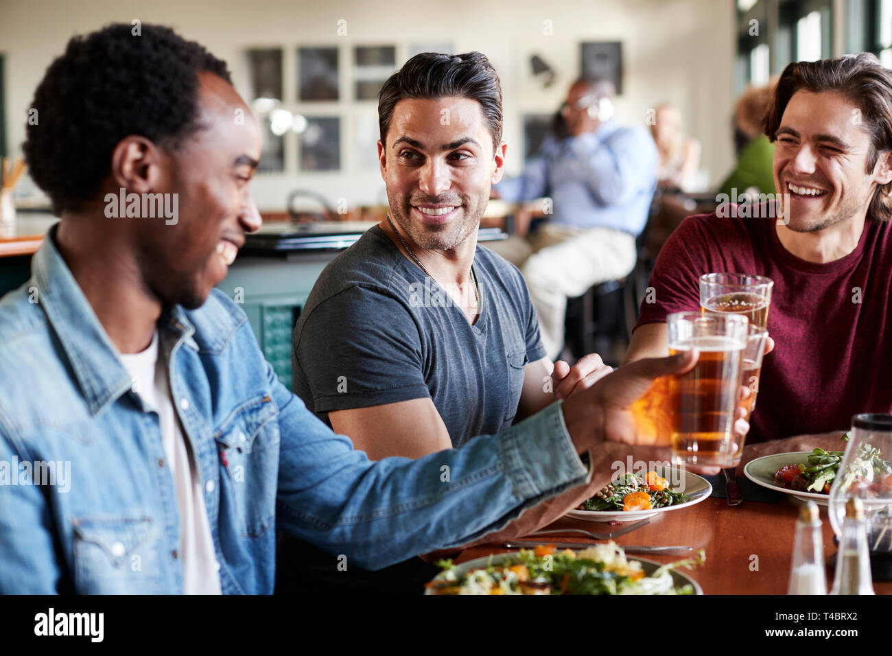 Happy friends restaurant dinner beer hi-res stock photography and ...