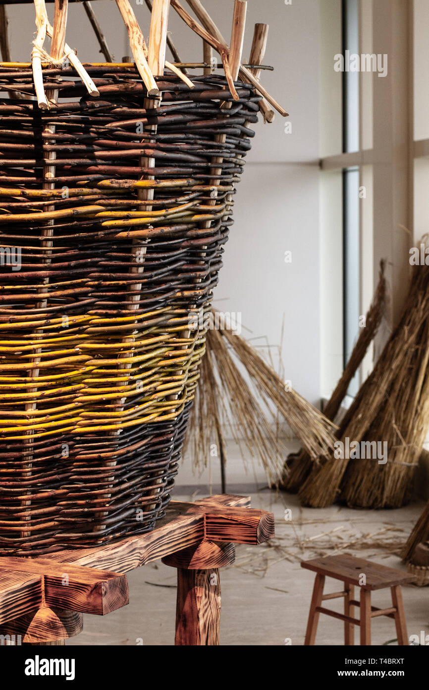 Big Wickerwork basket with vegetable material at background ...
