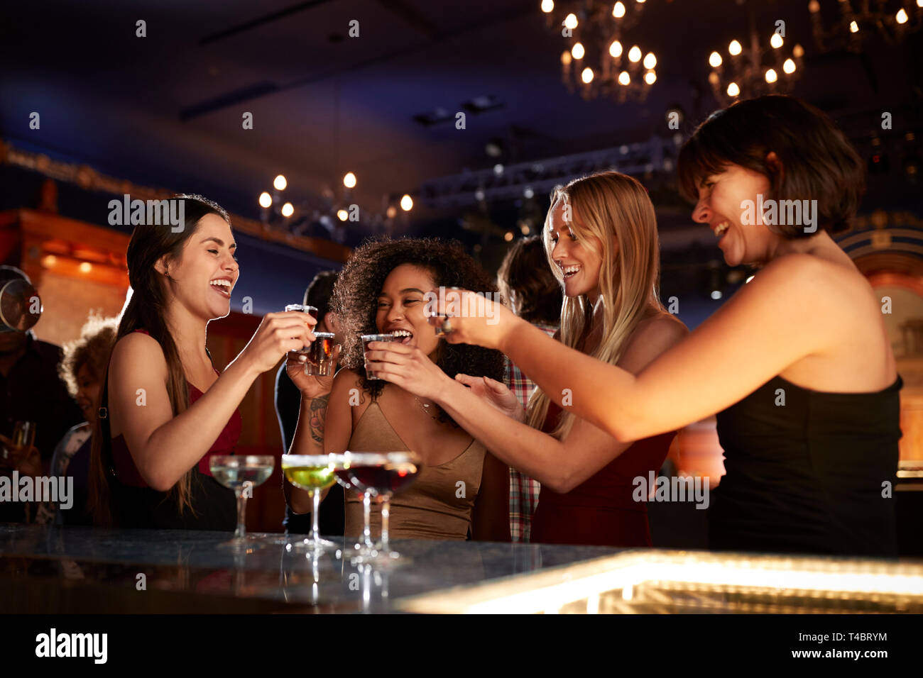 Group Of Female Friends Drinking Shots In Cocktail Bar Together Stock ...