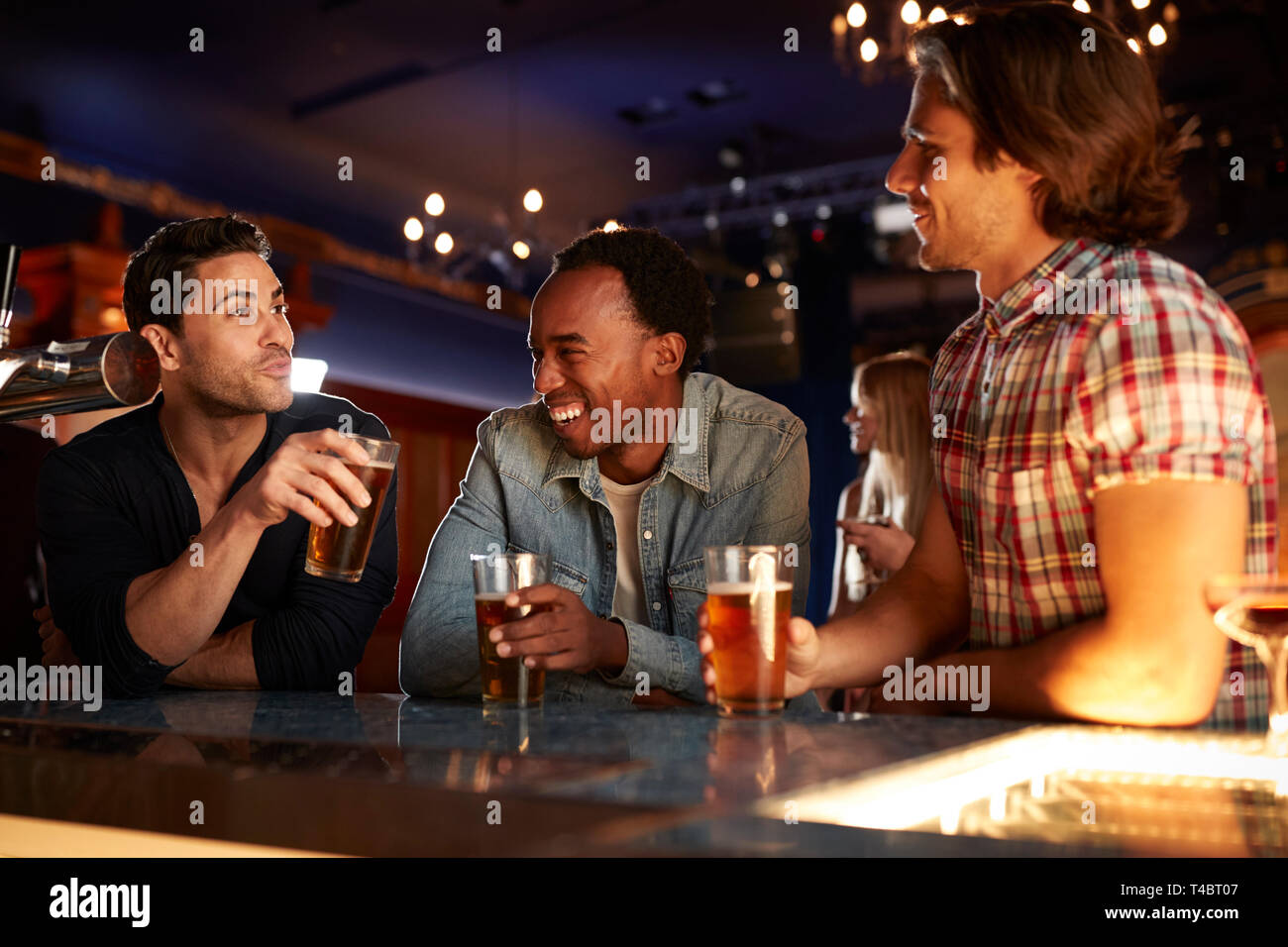 Group Of Male Friends Drinking Beer In Bar Together Stock Photo - Alamy