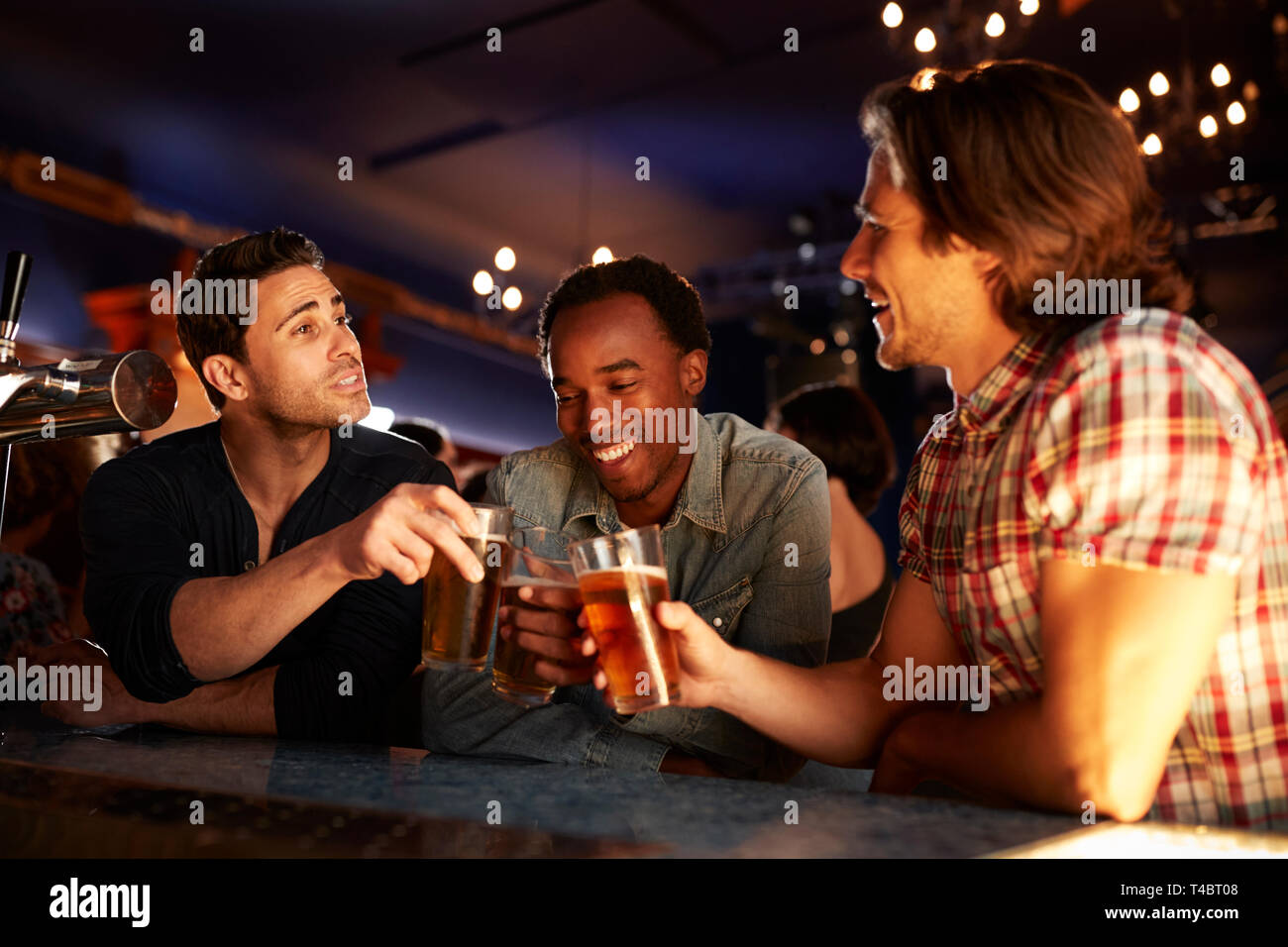 Group Of Male Friends Drinking Beer In Bar Together Stock Photo - Alamy