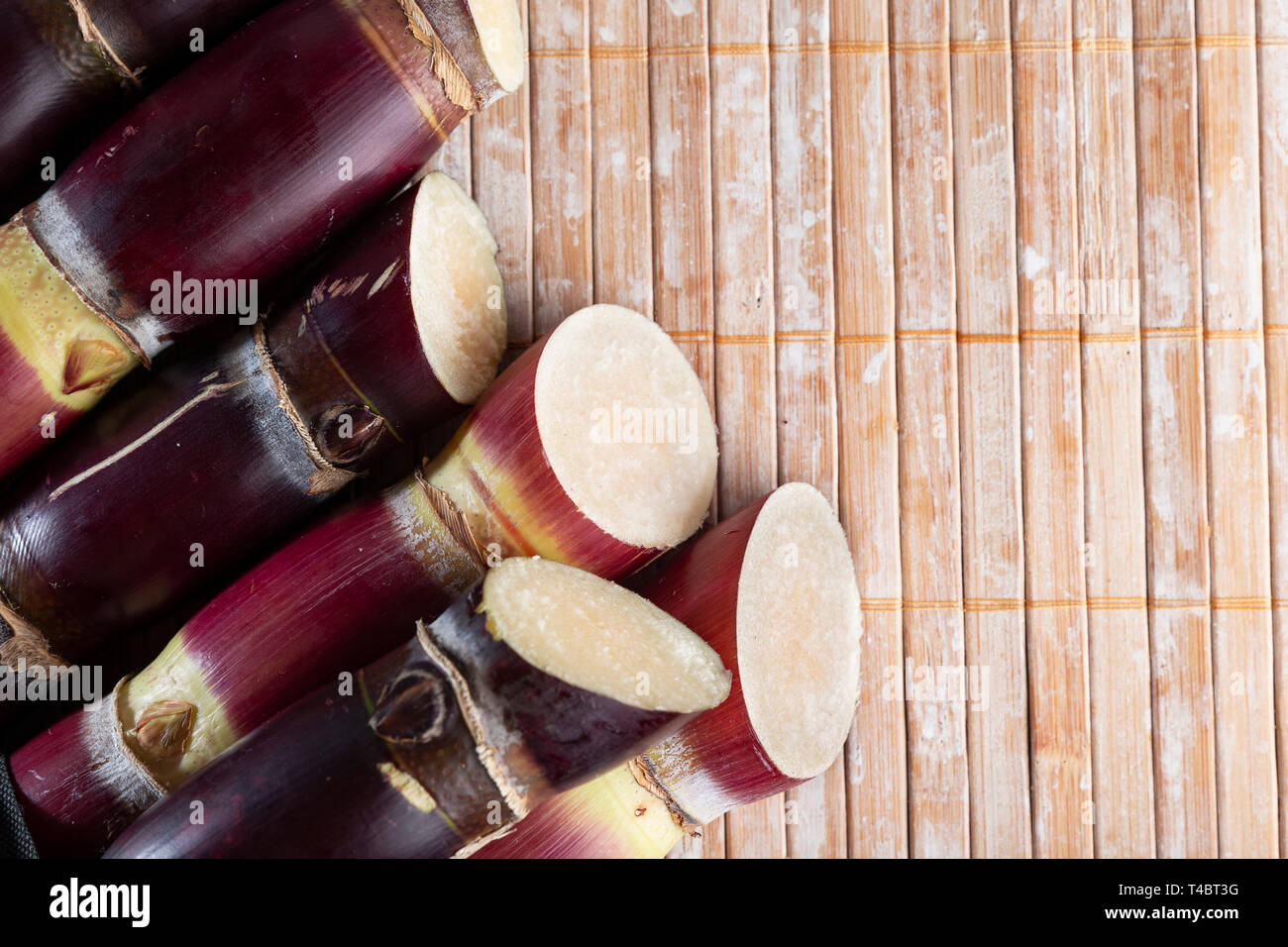 pile of sugar cane on wooden background, image Stock Photo - Alamy
