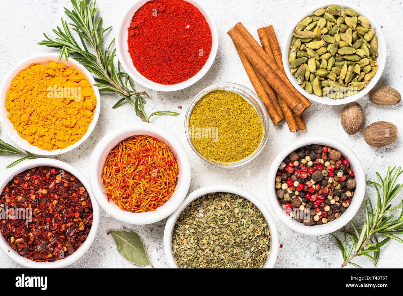 Set of spices in the bowls on white background. Curry, turmeric ...
