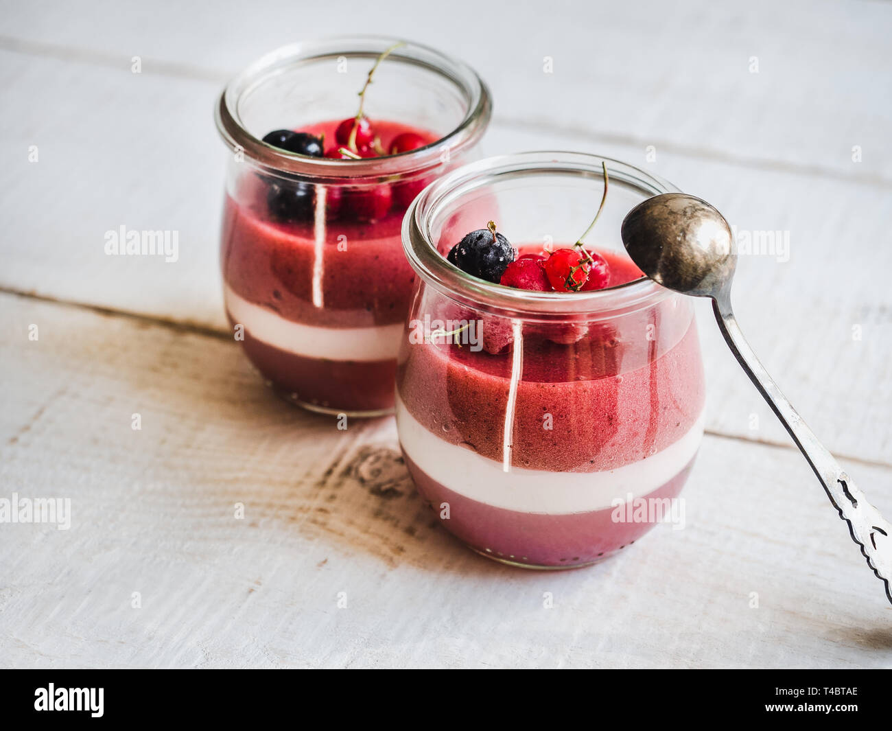 Puff souffle with ice cream and fresh berries on white boards. Close-up ...