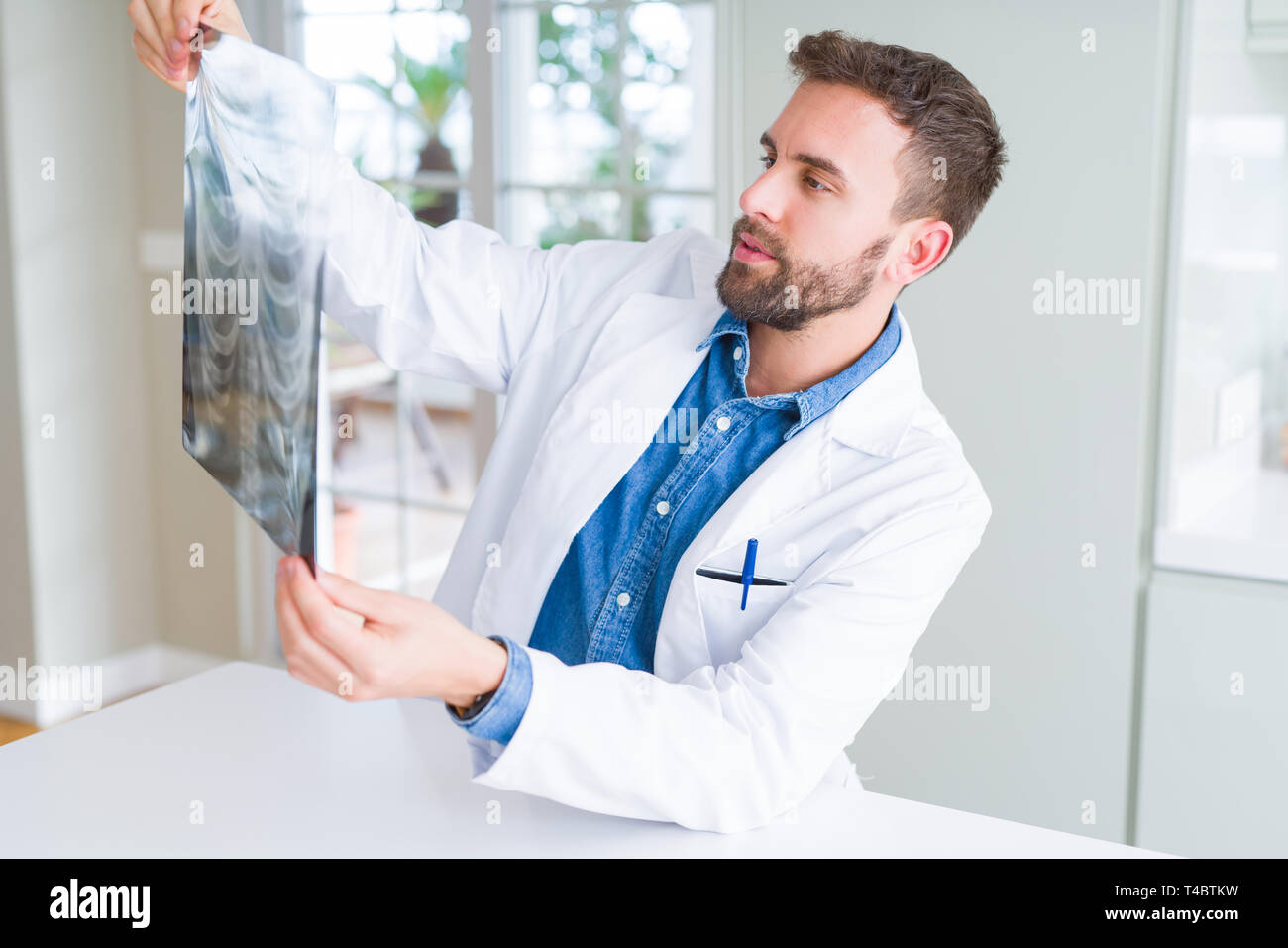 Doctor man looking at x-ray radiography doing body examination Stock ...