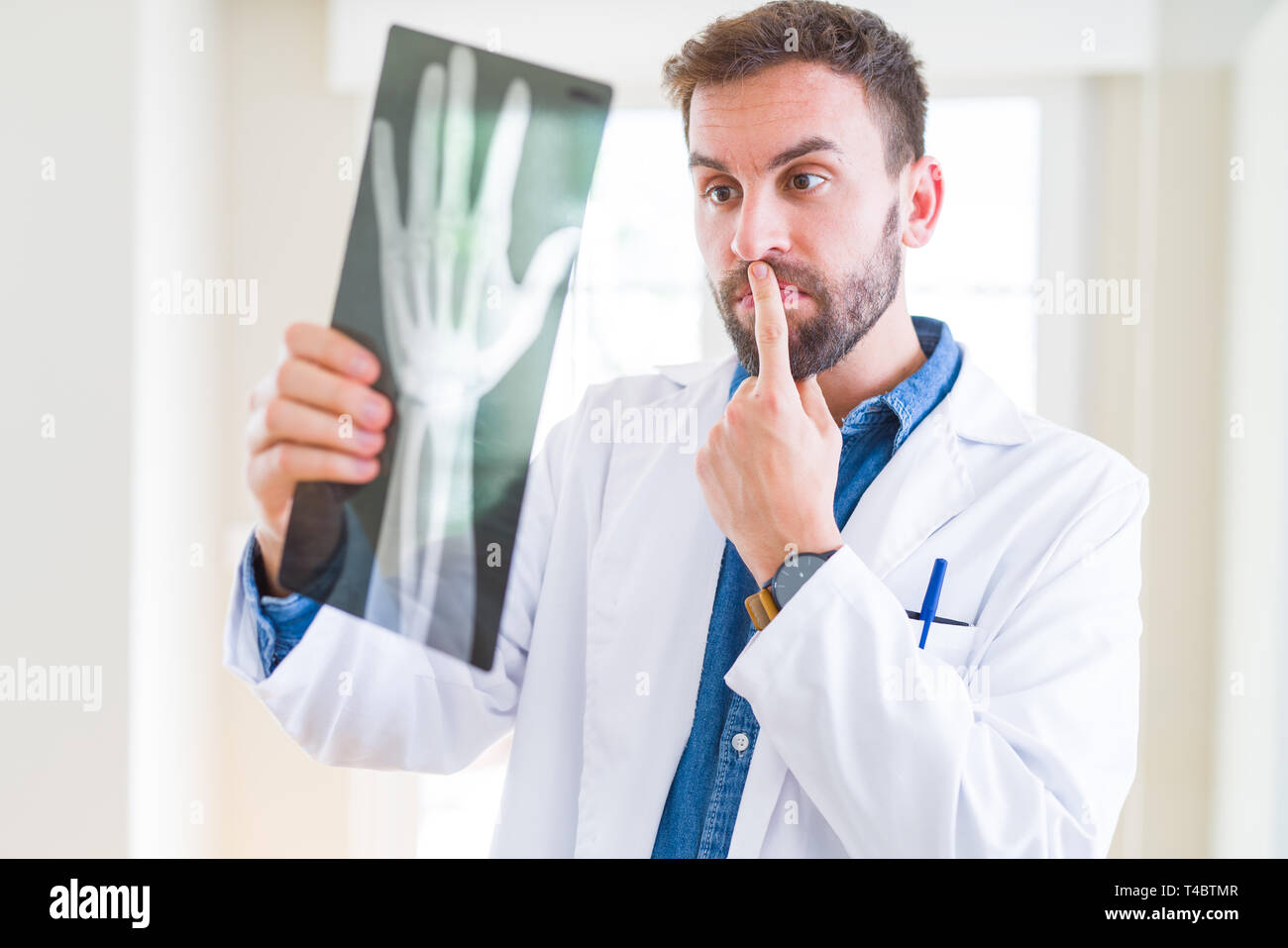 Doctor man looking at x-ray radiography doing body examination Stock ...