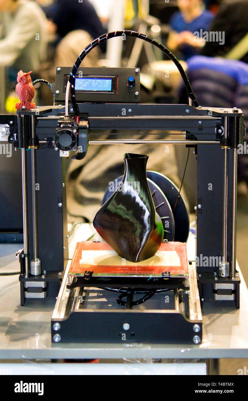 3D printer printing a model in the form of black vase close-up. The ...