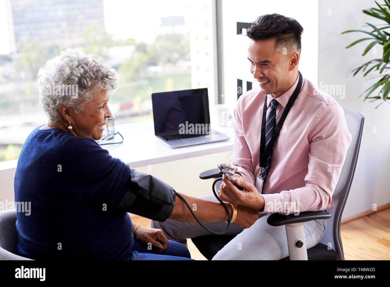 Blood pressure check in black patient hi-res stock photography and ...