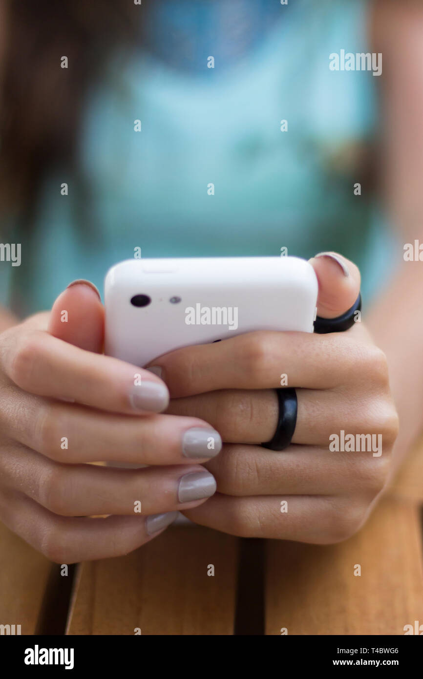 Picture of a girl using a cellphone to send text messages. Detail of ...