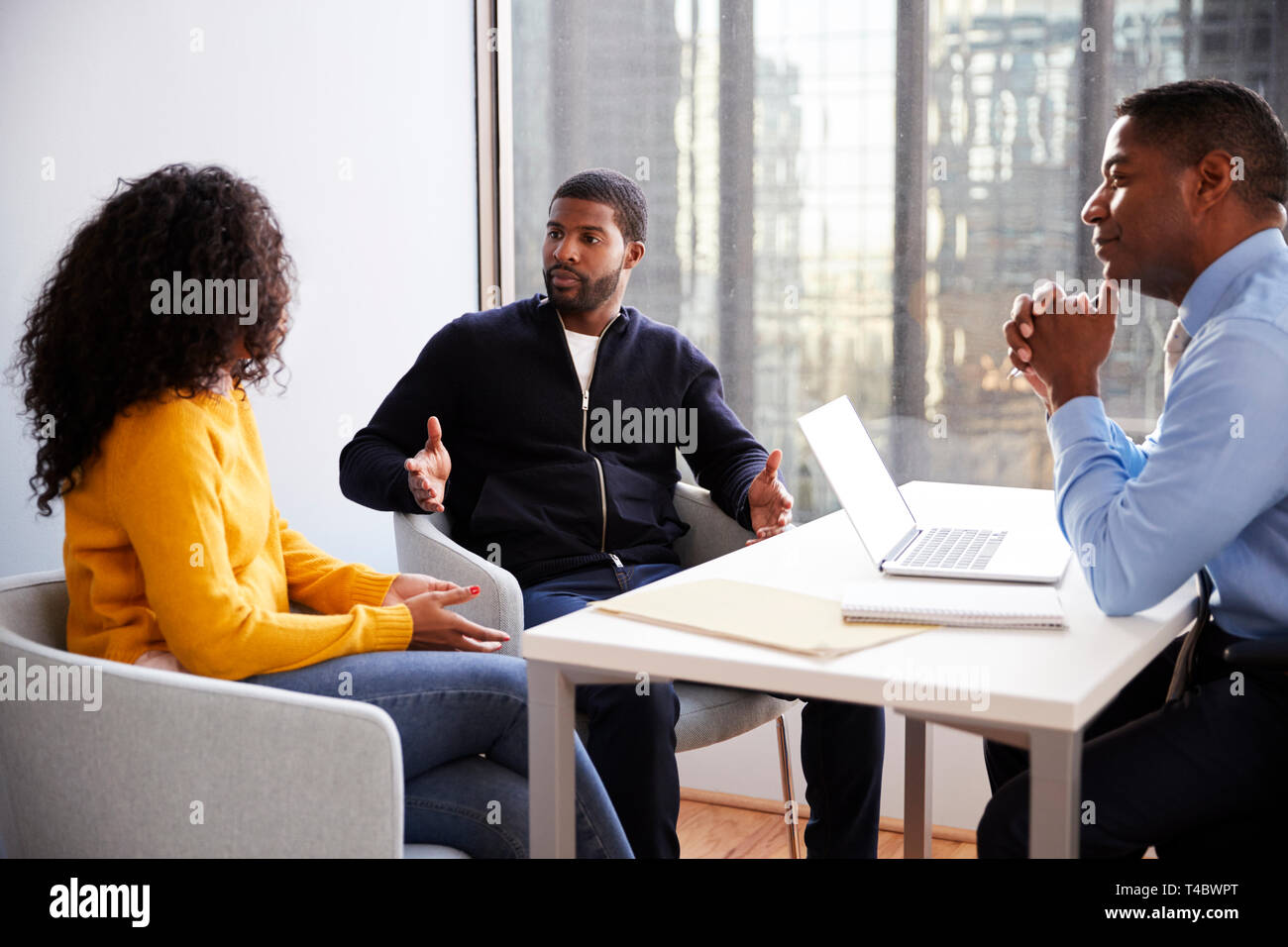 Couple Meeting With Male Financial Advisor Relationship Counsellor In ...