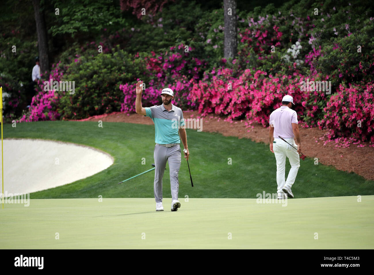 USA's Dustin Johnson, left, celebrates after chipping in for birdie on ...